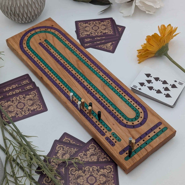 Handcrafted Cherry Wood Cribbage Board with Purple and Green Inlay
